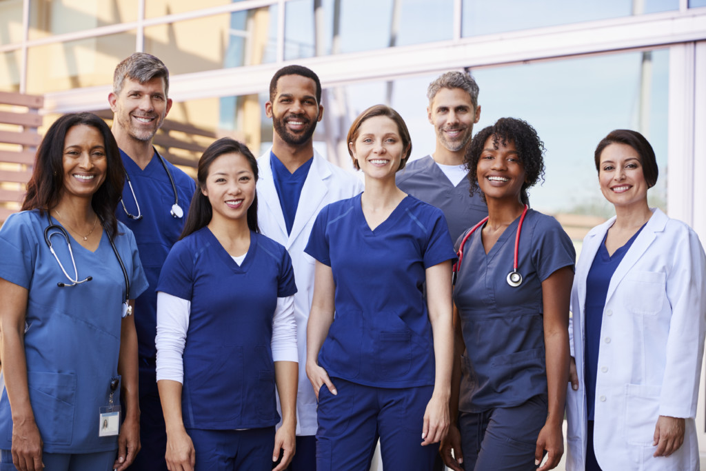 Smiling medical team standing together outside a hospital - Tri-City ...